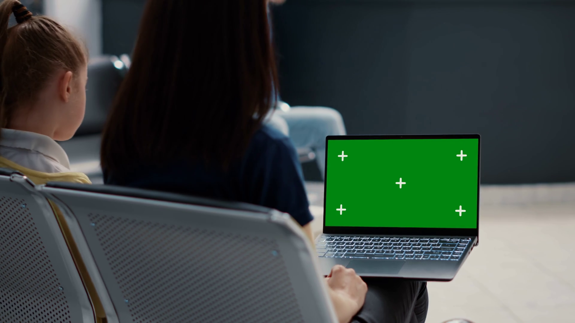 Mother and small kid holding laptop with greenscreen background in ...