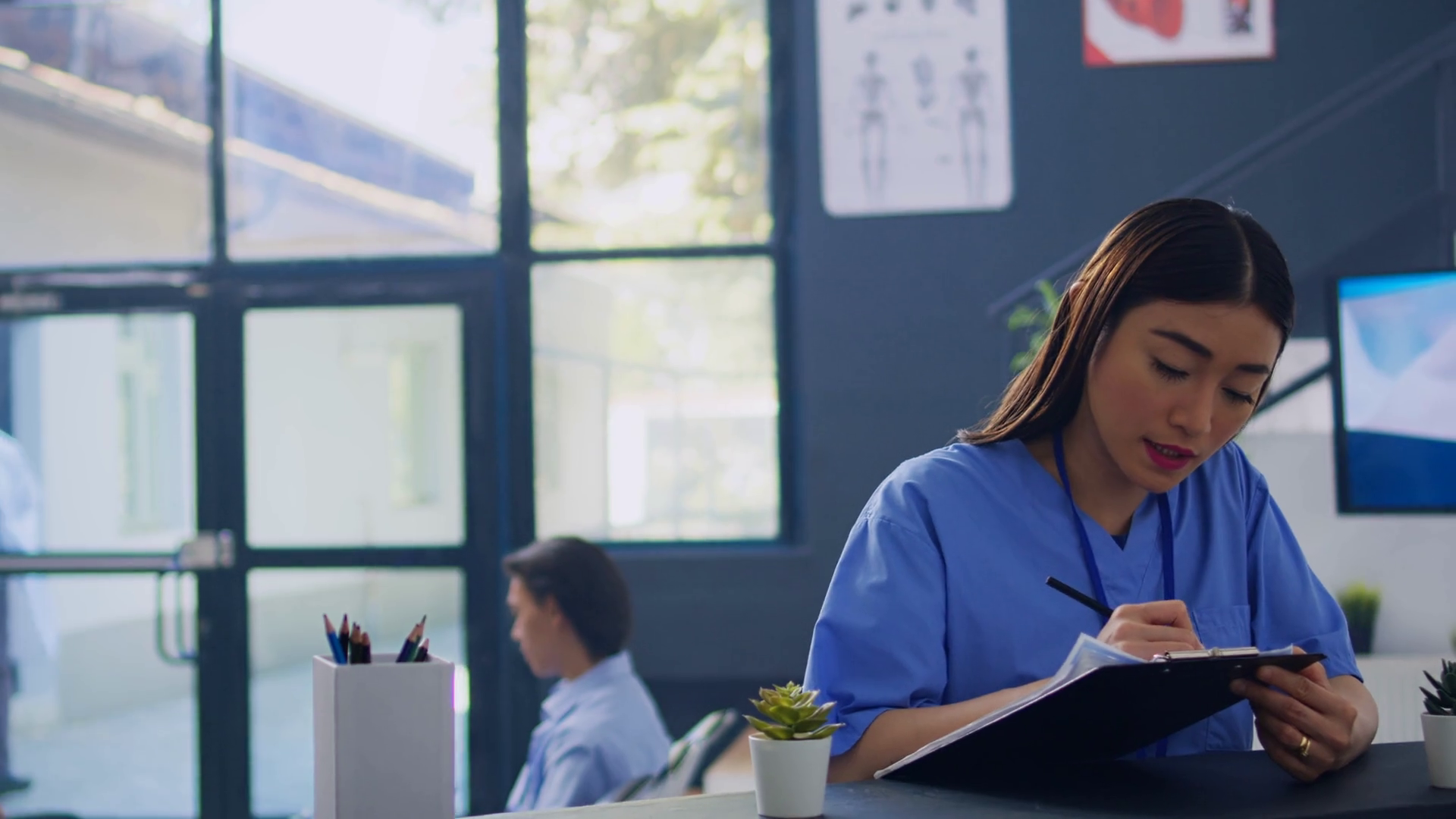 Assistant Standing At Hospital Counter Desk Stock Footage SBV-347546372 ...