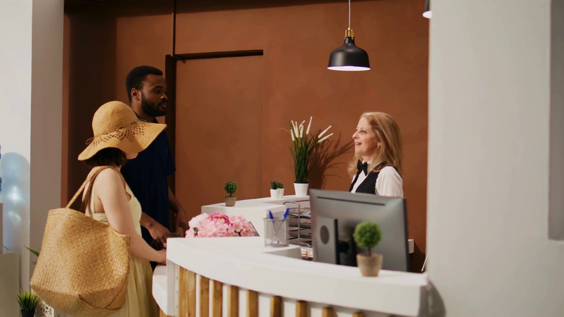 Hotel Staff Welcoming Guests At Front Desk Stock Footage SBV-347705187 ...