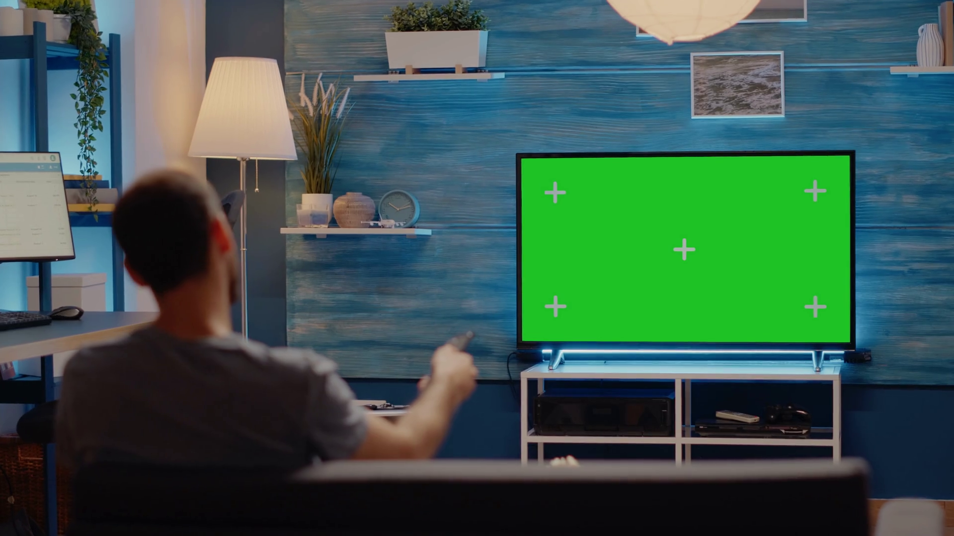 Caucasian man switching channels on green screen television display in ...