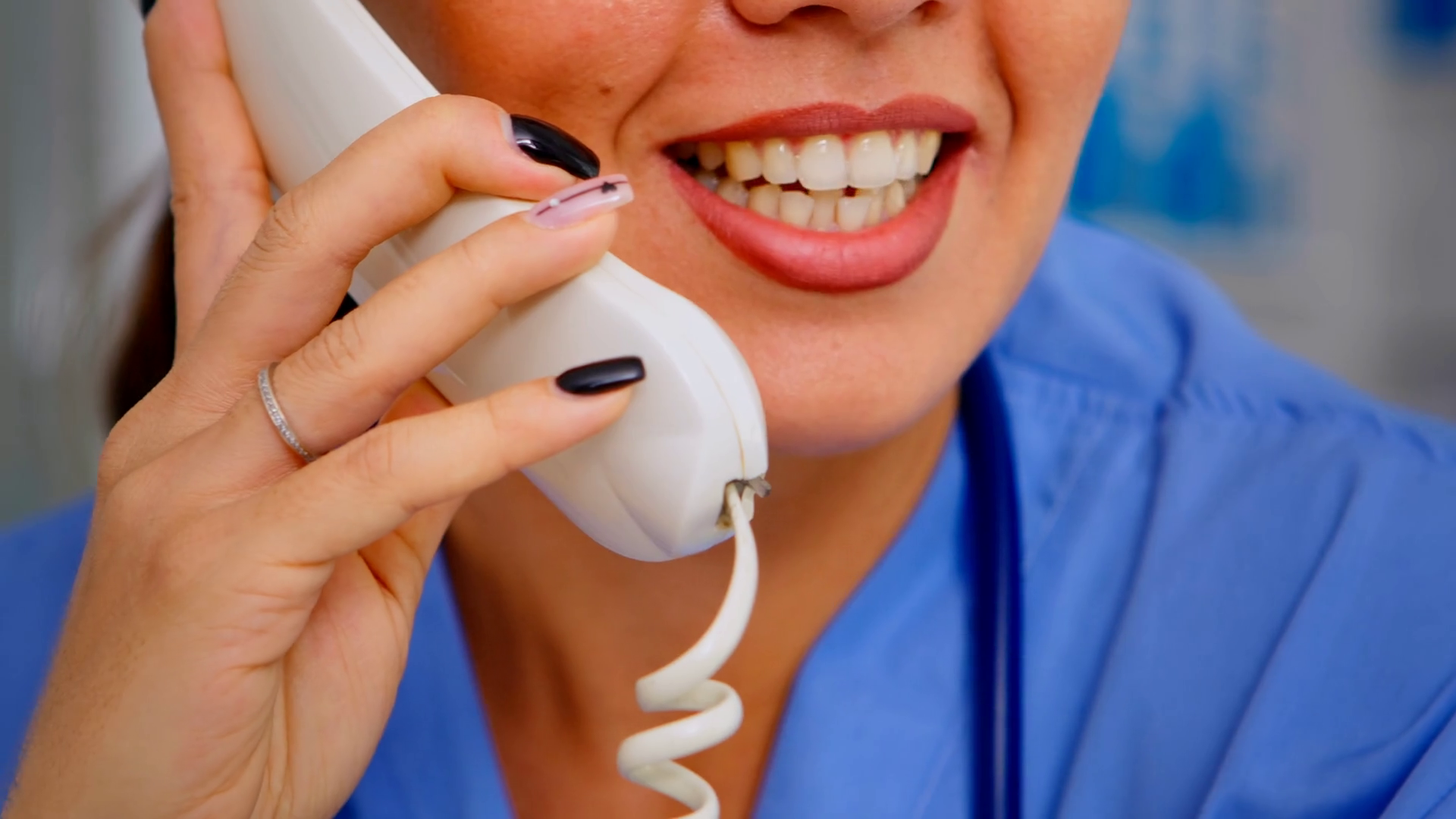 Close up of specialist practitioner talking at phone during telehealth ...