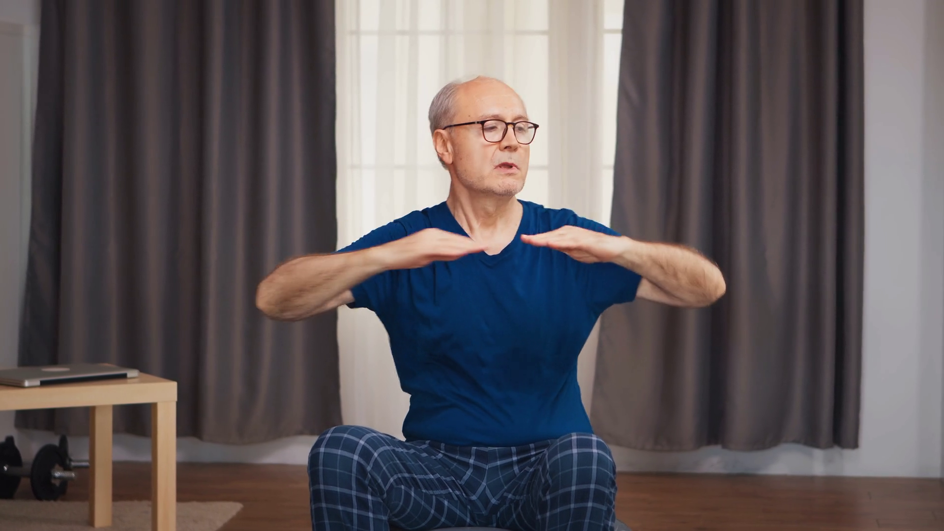 Elderly man exercising in living room sitting on stability ball. Old ...