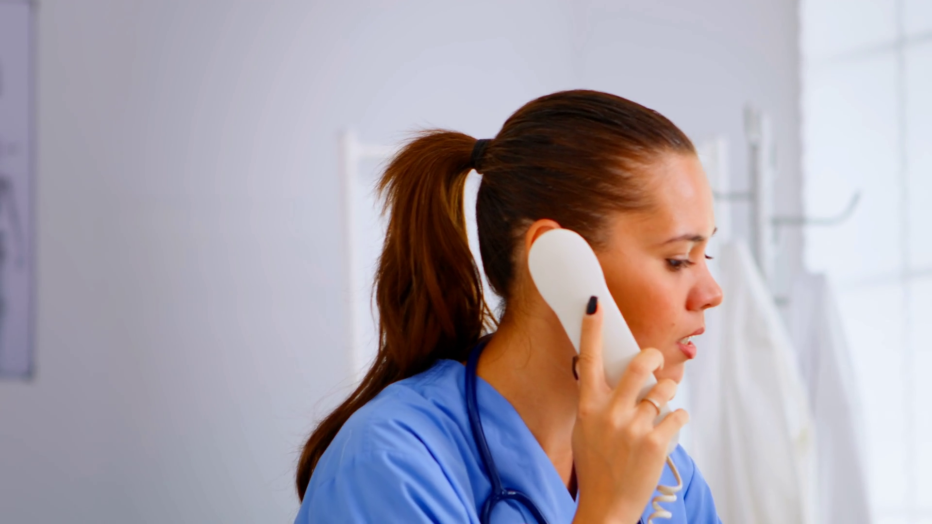 Medical Receptionist Answering Phone Calls Stock Footage SBV-346391546 ...