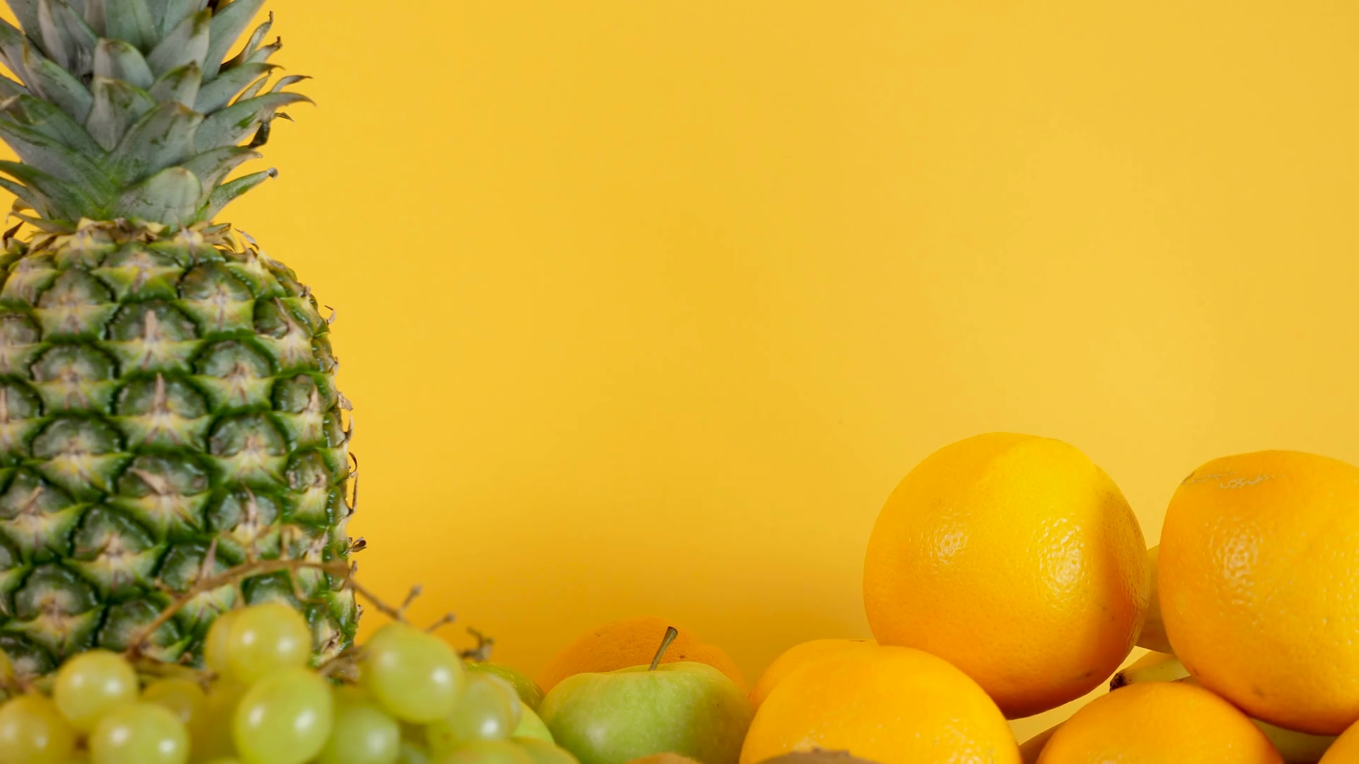 Organic and natural mix of fruits on yellow background. Zoom out dolly ...
