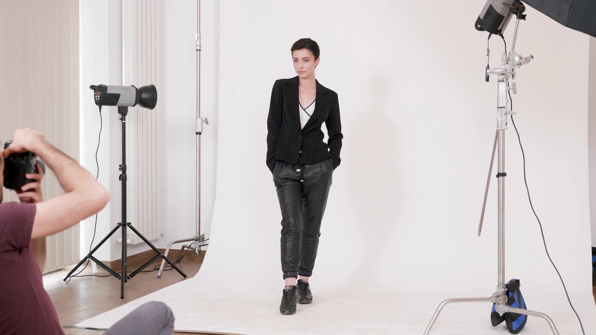 Photographer working with a professional model in the studio. Backstage ...