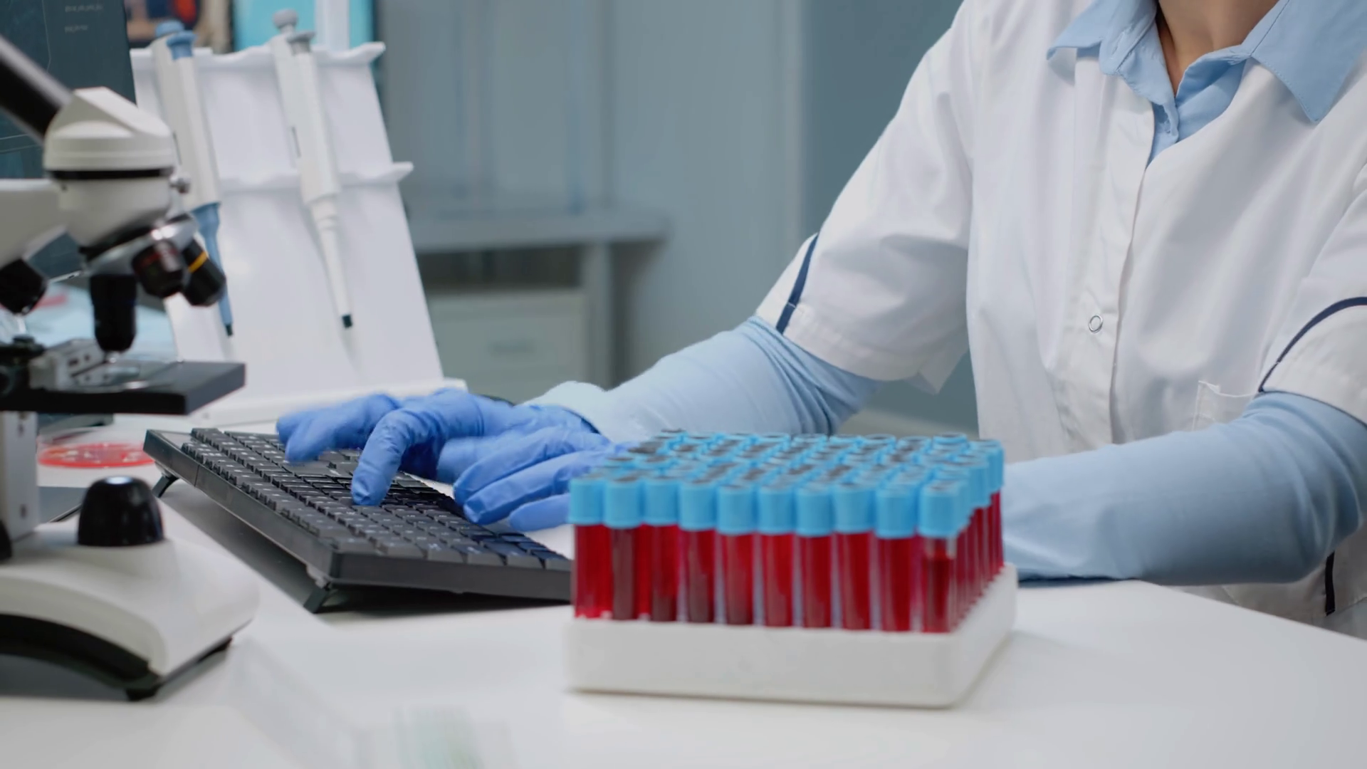 Scientific doctor analyzing sample of blood from vacutainer in ...