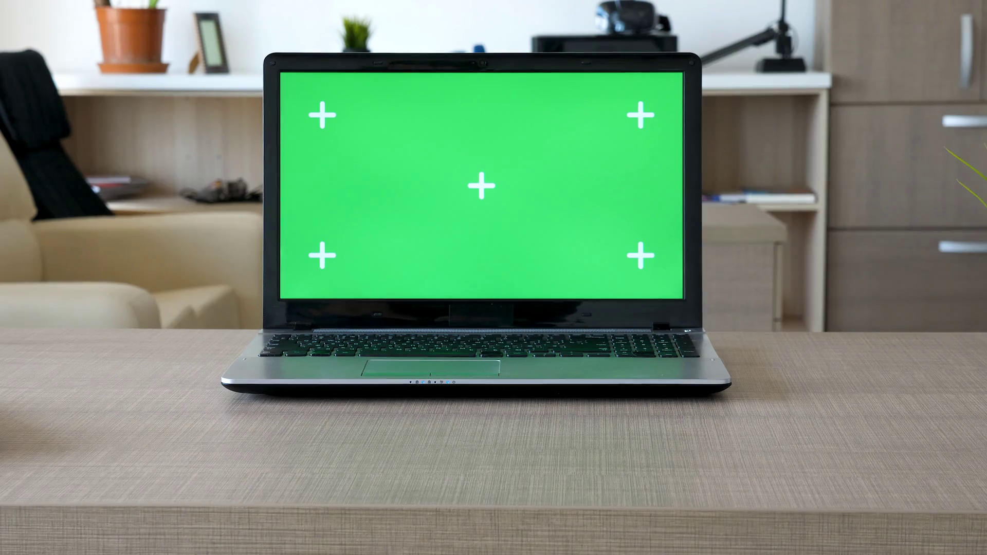 Zoom in shot on a computer screen with chroma mock up on a desk in the ...