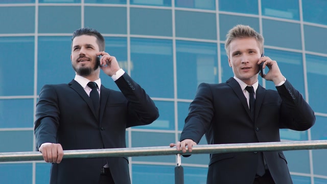 Two Business Men Standing And Talking Stock Footage: Royalty-Free Video ...