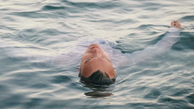 Man Floating In Water Stock Footage: Royalty-Free Video Clips - Storyblocks