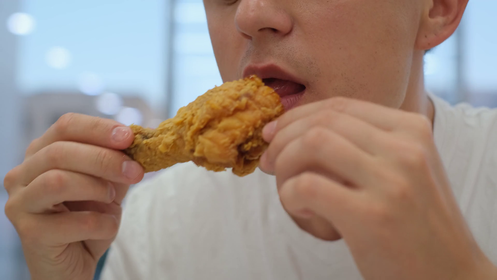 A Man Eats Appetizing Fried Chicken Leg In Stock Footage SBV-347773020 ...