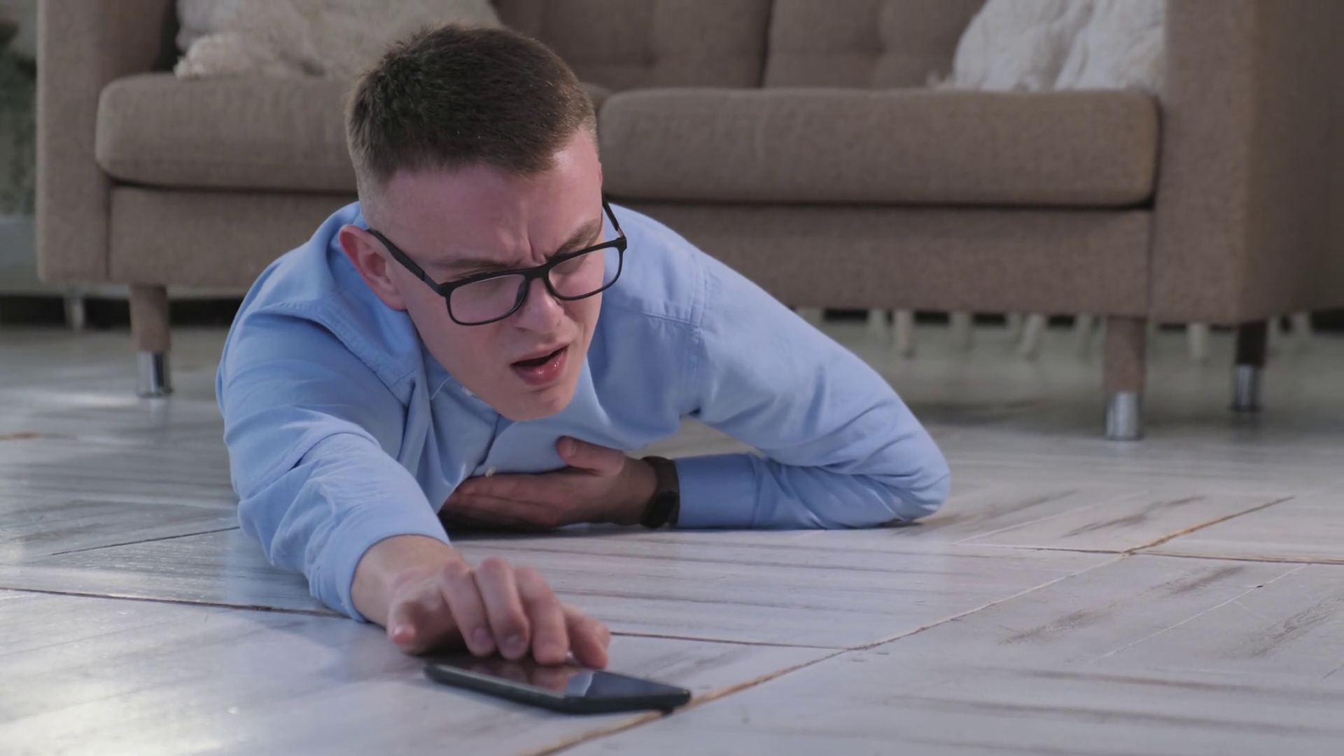 Heart attack. Man lying on the floor and holding his heart, trying to ...