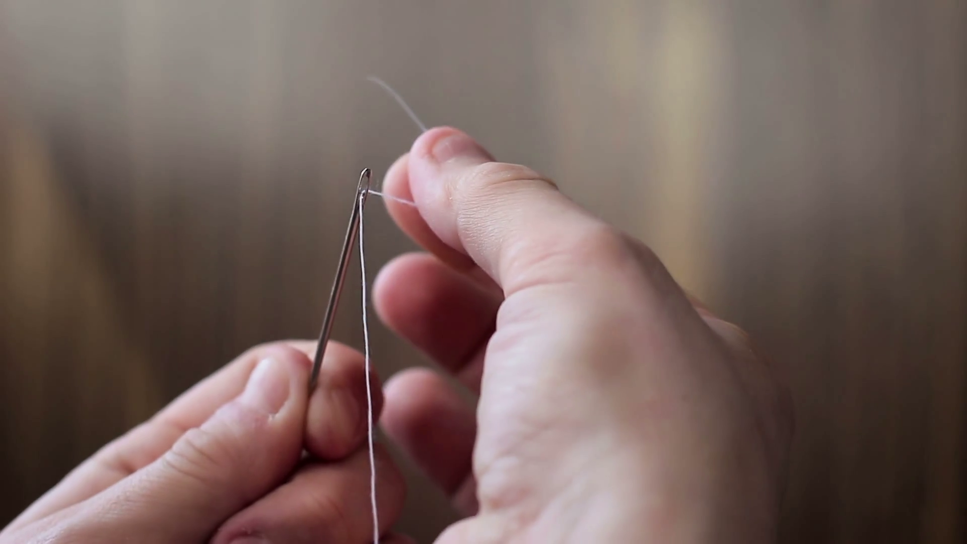A young tailor or shoemaker inserting a thread into the needle. Easy ...