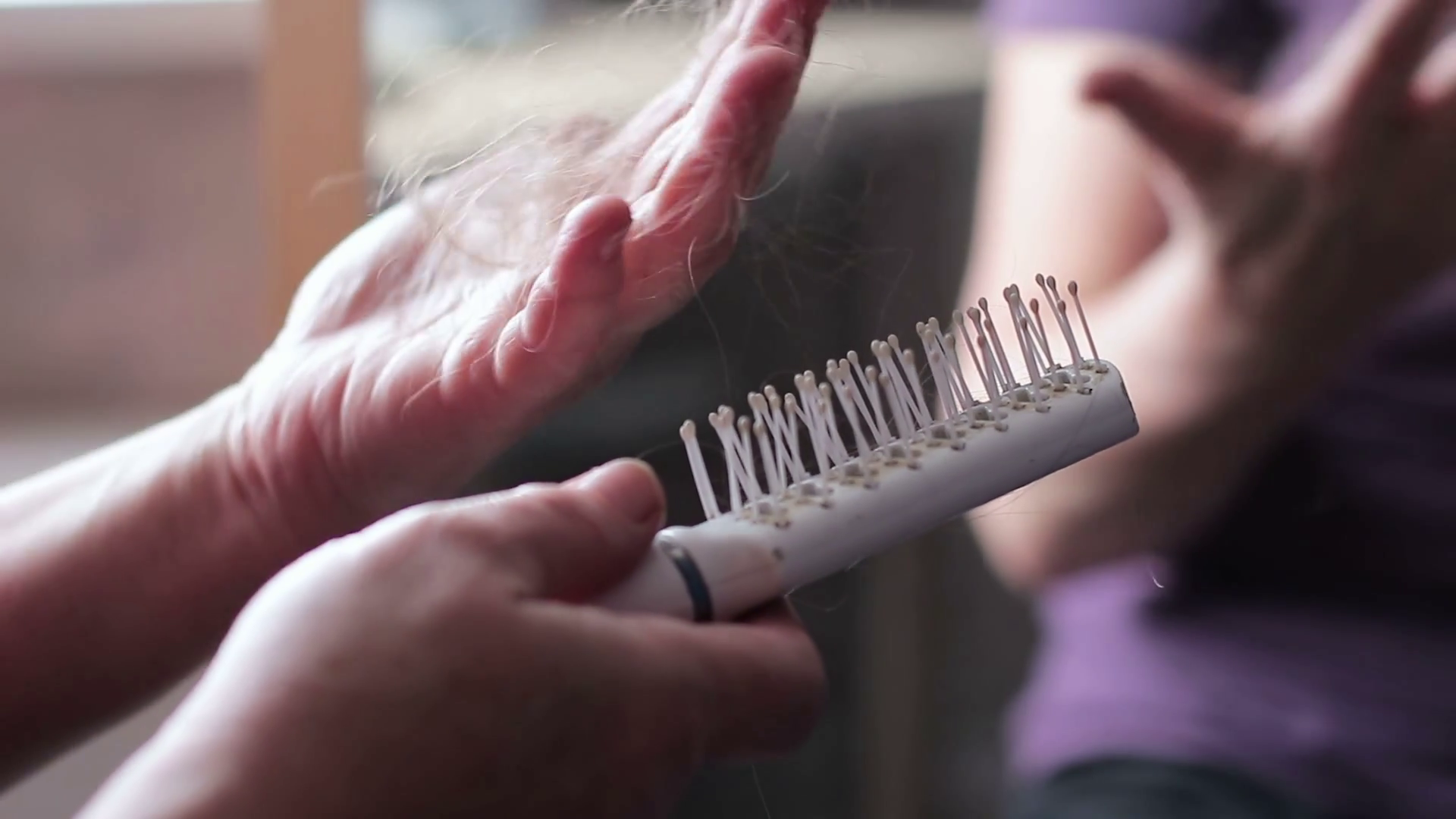 Drop-down hair in female hands with comb Stock Video Footage - Storyblocks