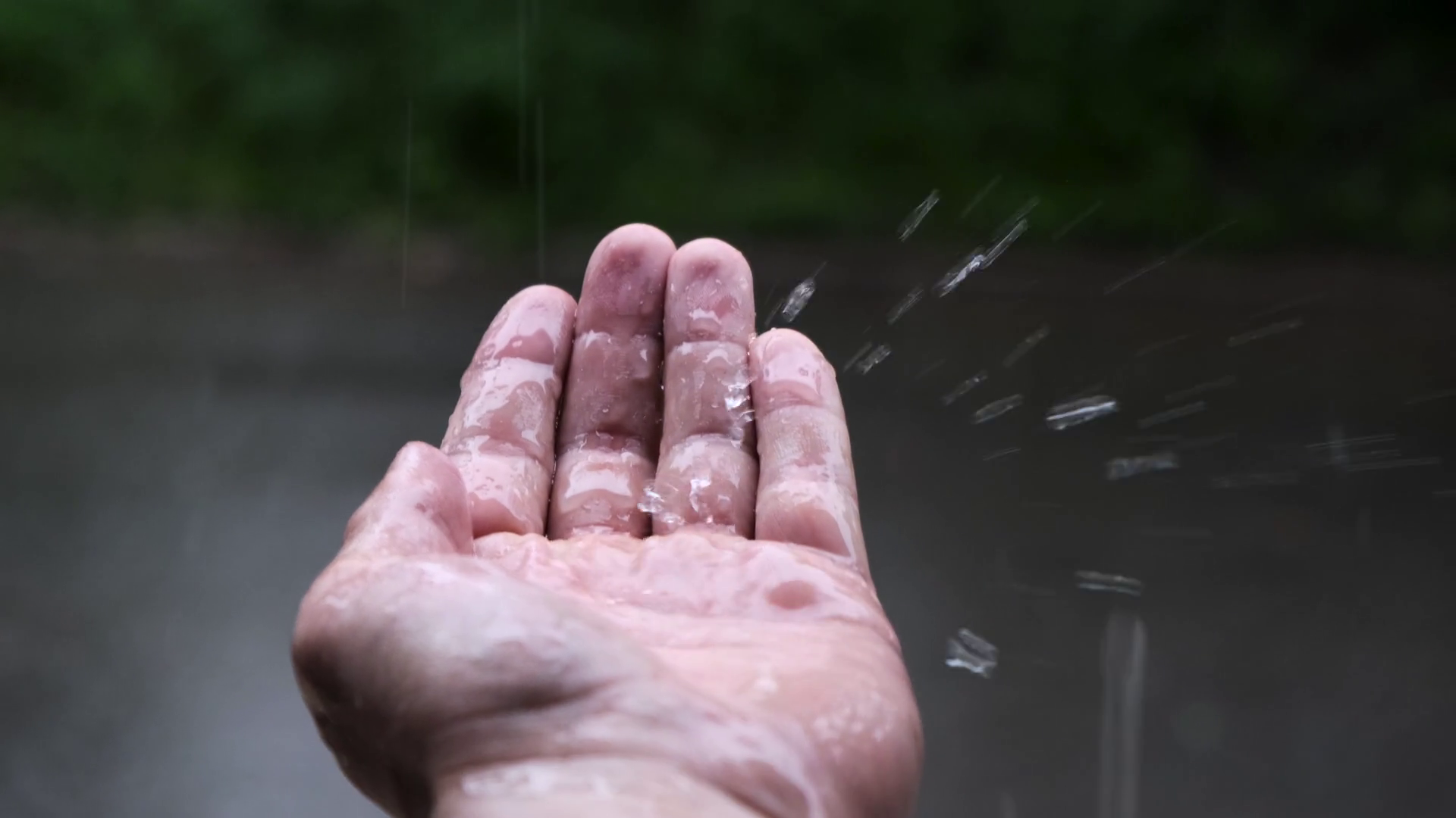 Rain falls on a man's hand close up Stock Video Footage - Storyblocks