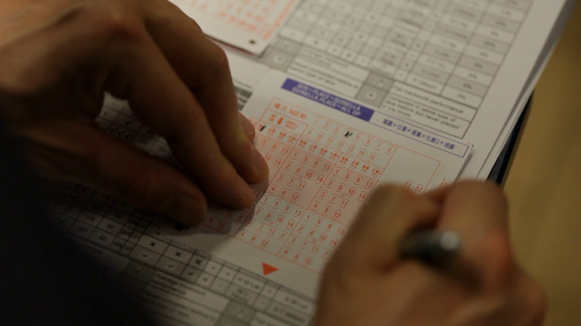 A Man's Hands Fill Out Asian Betting Form Stock Footage SBV-324553306 ...