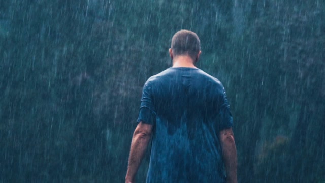 Man Walking In Rain