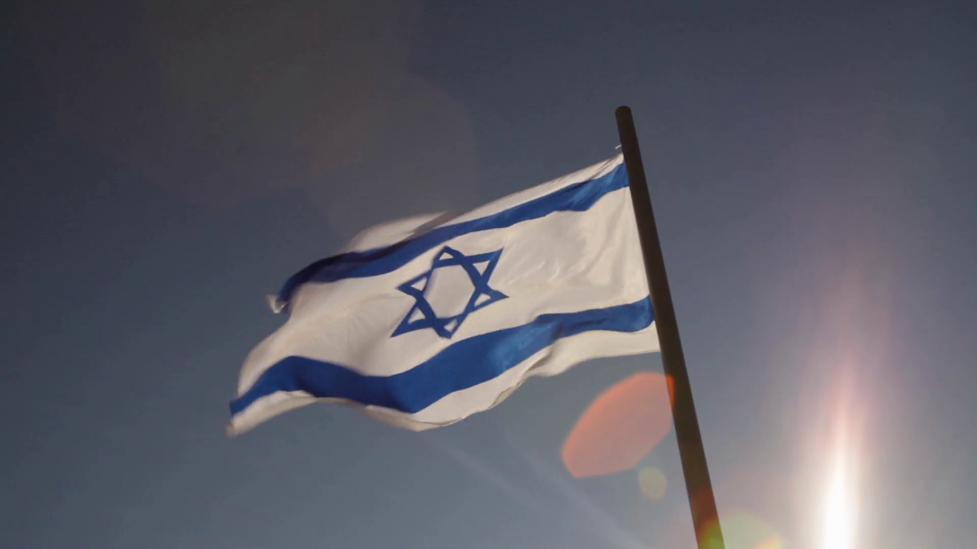 The Sun Creates Flares Behind Israeli Flag Stock Footage SBV-324516461 ...