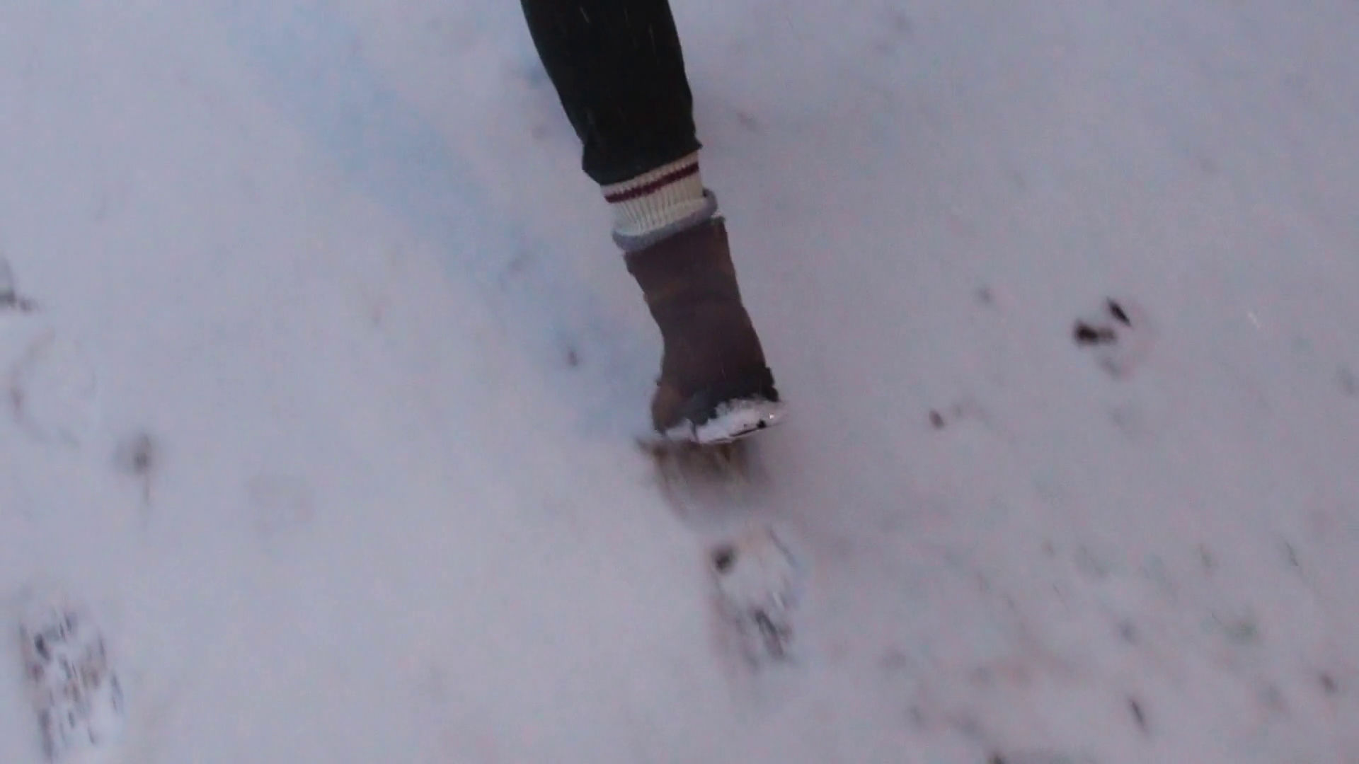 Young woman's legs leave prints running through fresh snow in slow ...