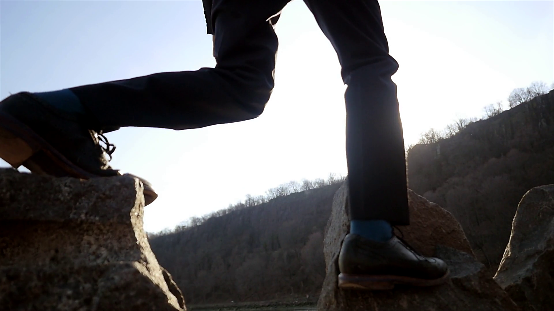 feet walking over stone rocks overcoming obstacles shot in slow motion ...