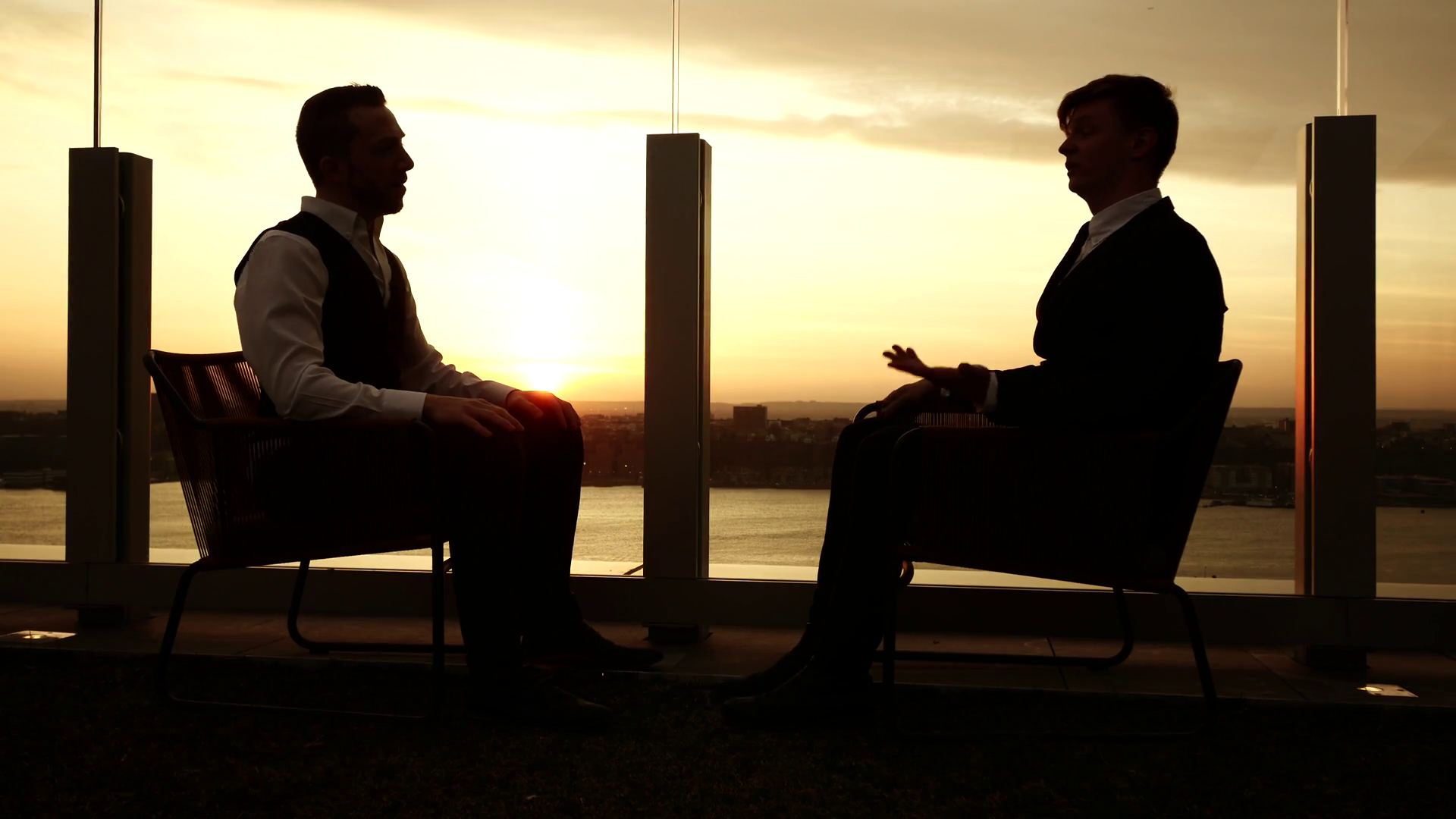 outdoors business meeting at sunset magic hour light. two man talking ...