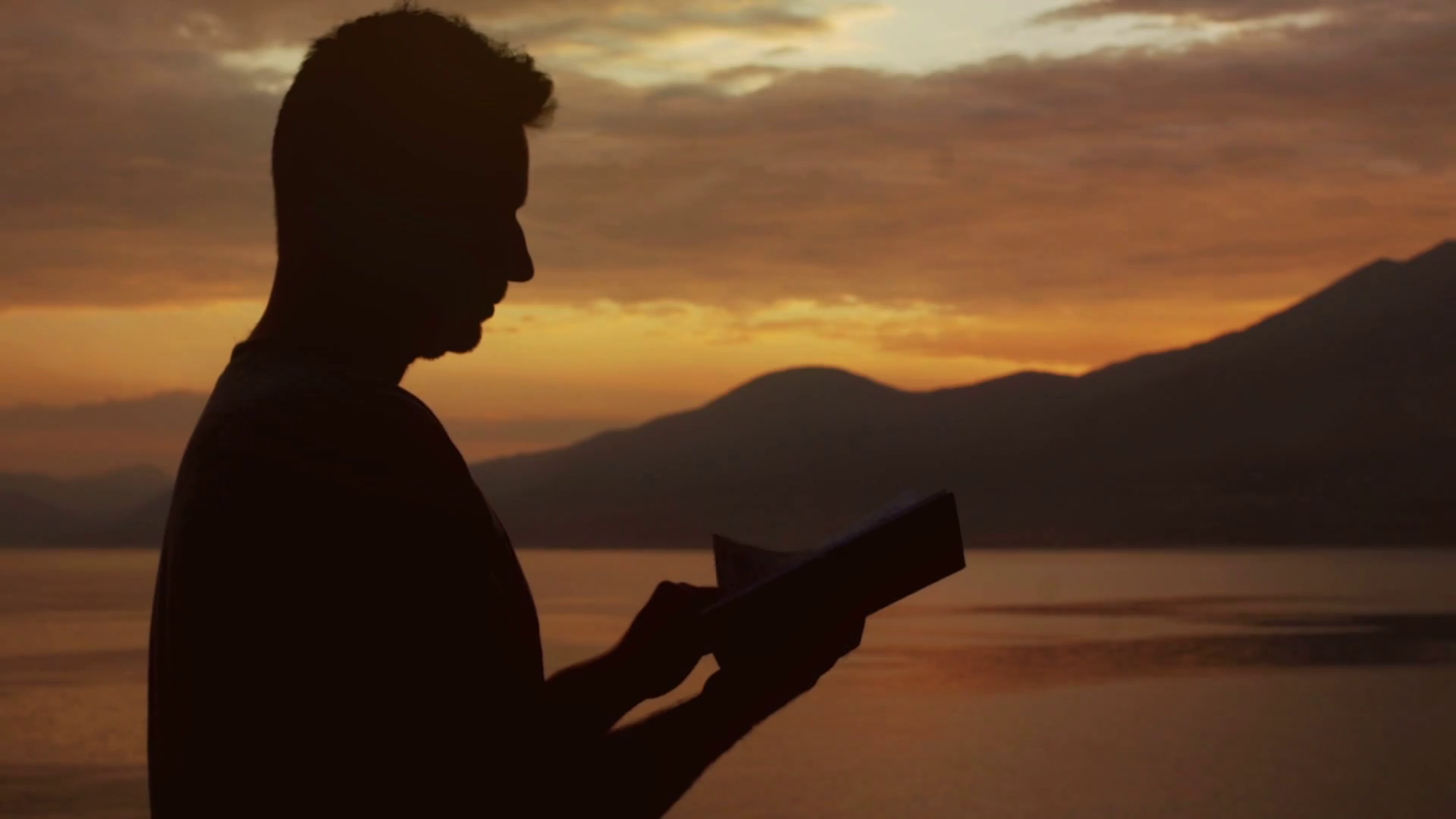 Man Reading Book Standing Next To Sea At Stock Footage SBV-309087853 ...