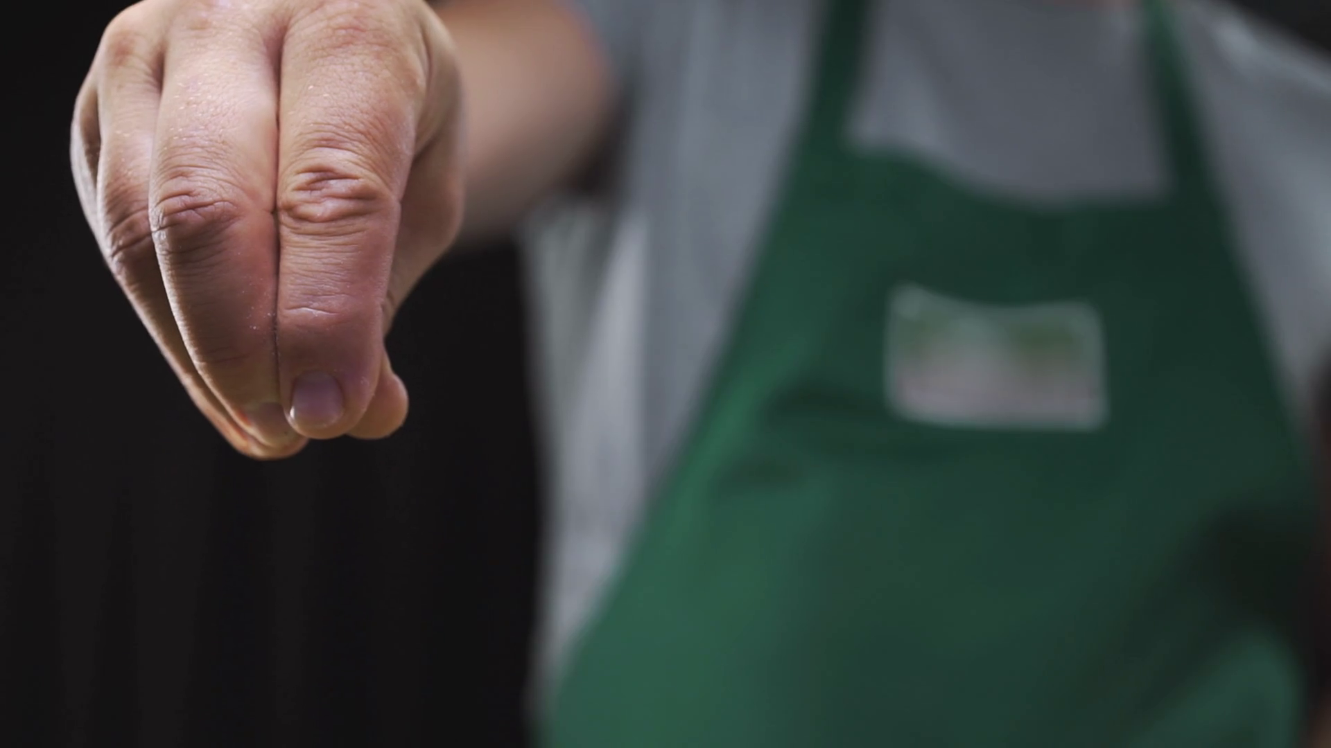 Close up shot: chef adds coarse salt to the dish, cooking in slow ...