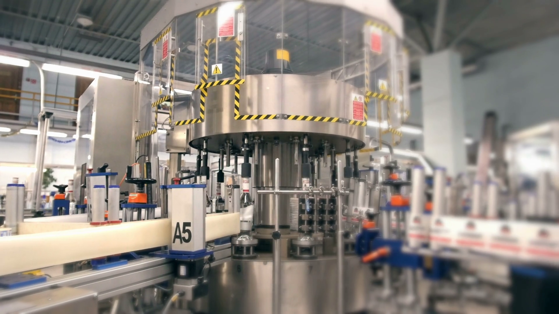 Bottling and sealing conveyor line at winery factory, labeling machine ...