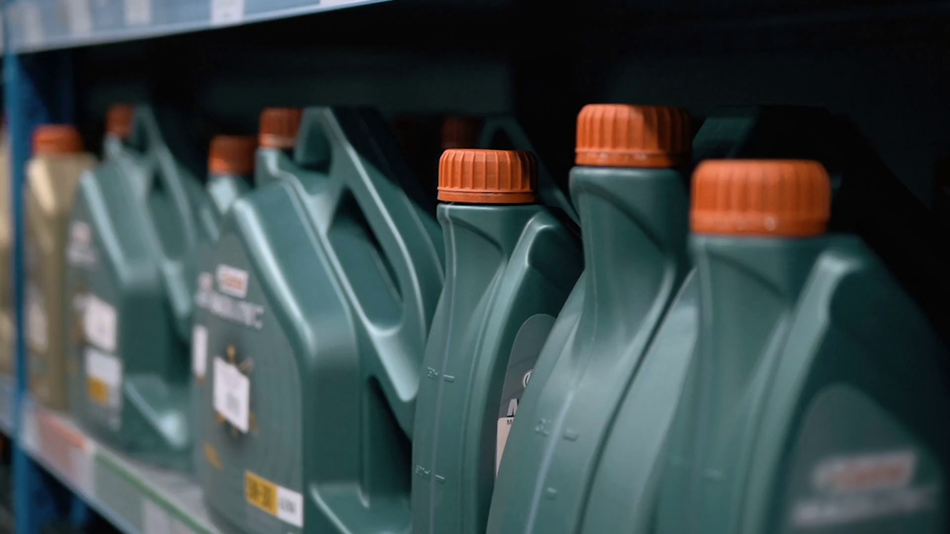 Car mechanic man choose motor oil for car at repair service station ...