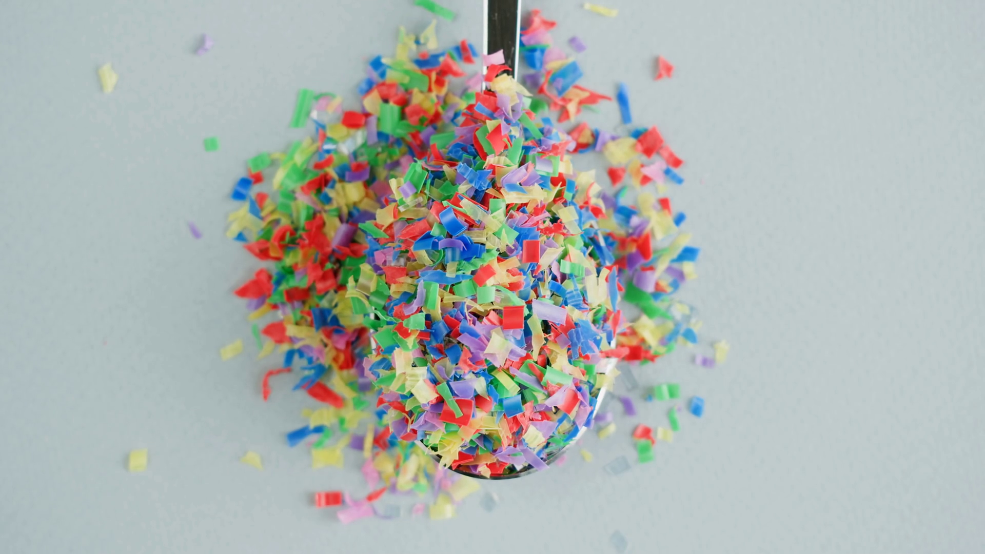 Microplastic pollution, plastic particles in spoon close-up, garbage ...