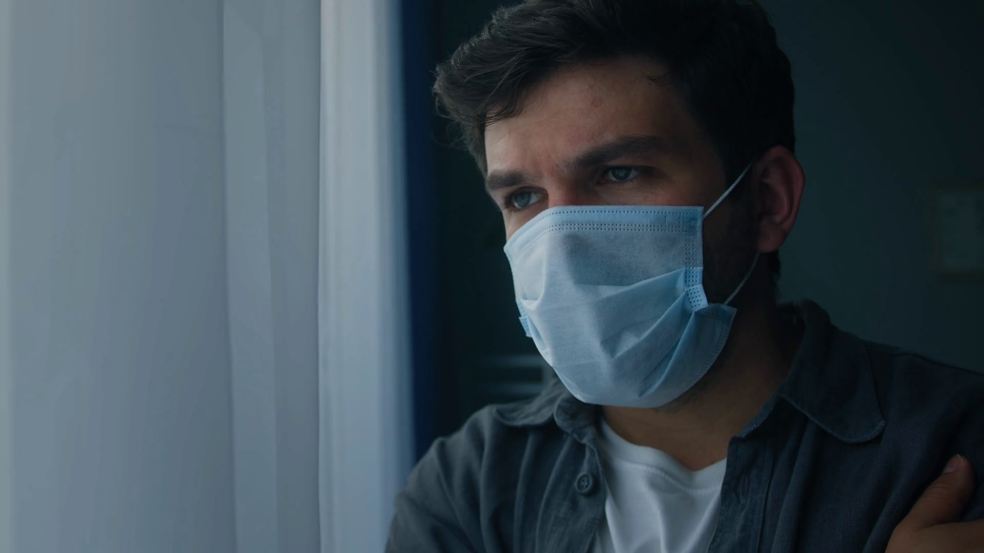 Brutal sad man wearing protective medical mask on face. Despairing ill ...