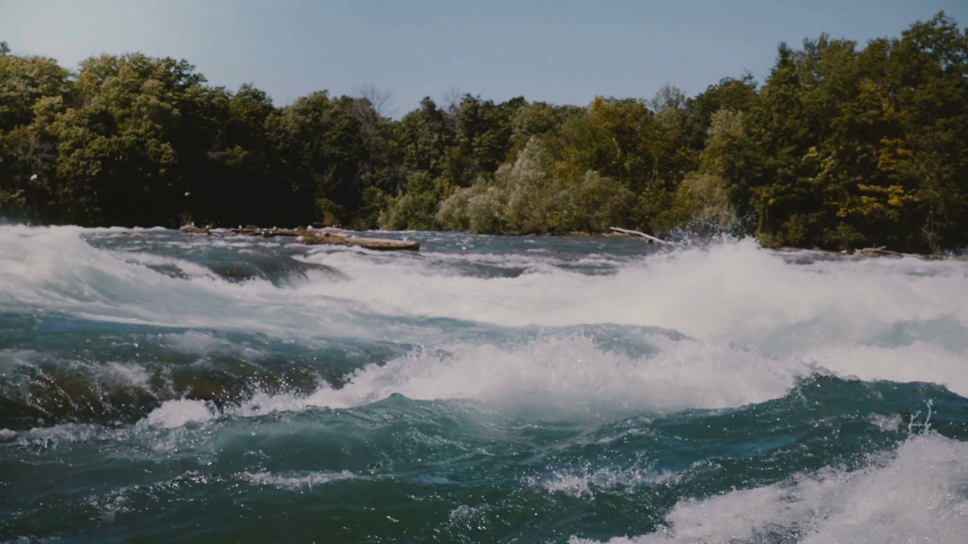 Close-up shot of rushing dangerous fast river, foam on water rapid ...