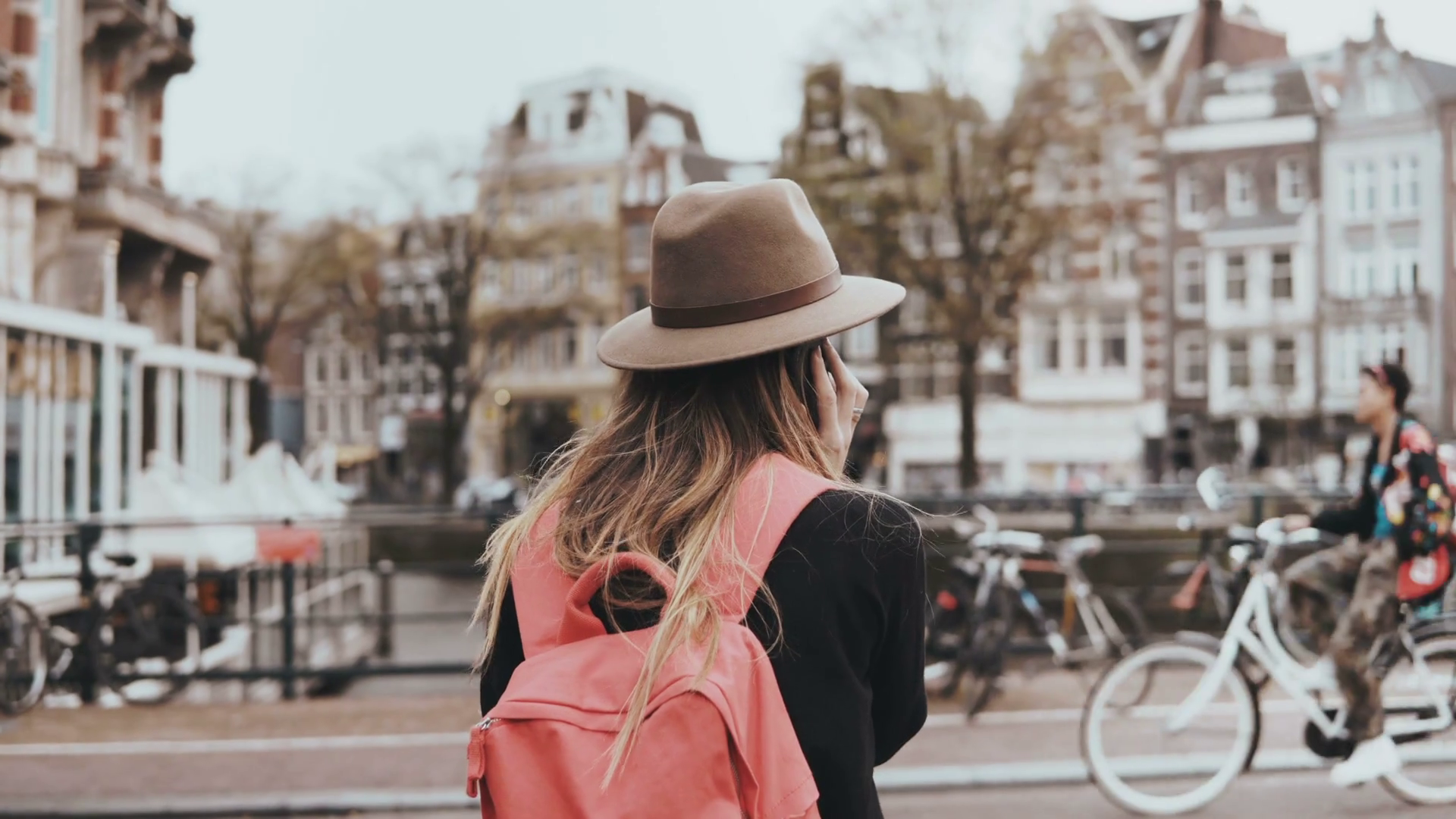Pretty woman making a phone call. Back view 4K. Young female with long ...