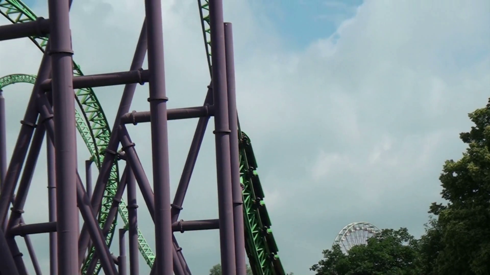 Drops and Turns around Green and Purple Roller Coaster Stock Video ...
