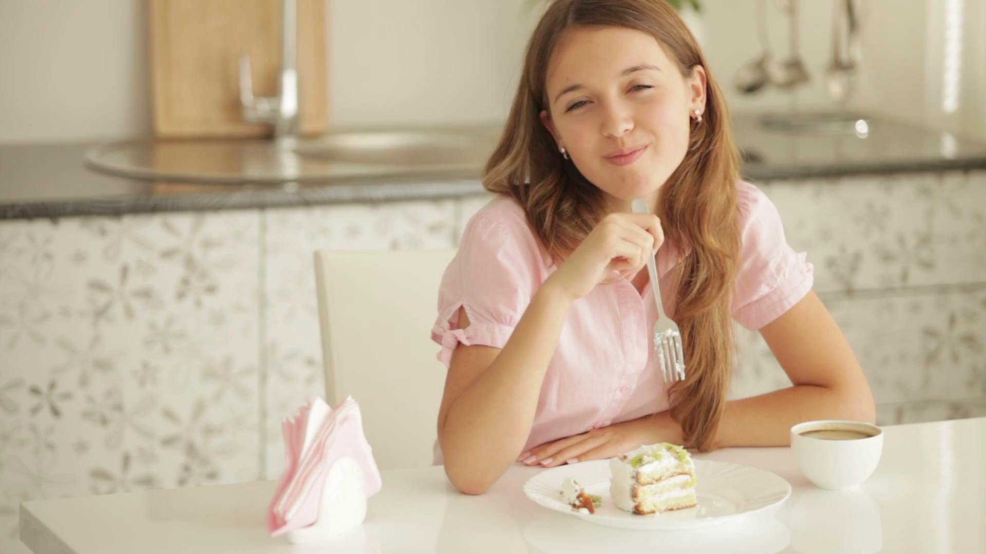 Happy Girl Sitting At Kitchen Table Eating Stock Footage SBV-303980567 ...