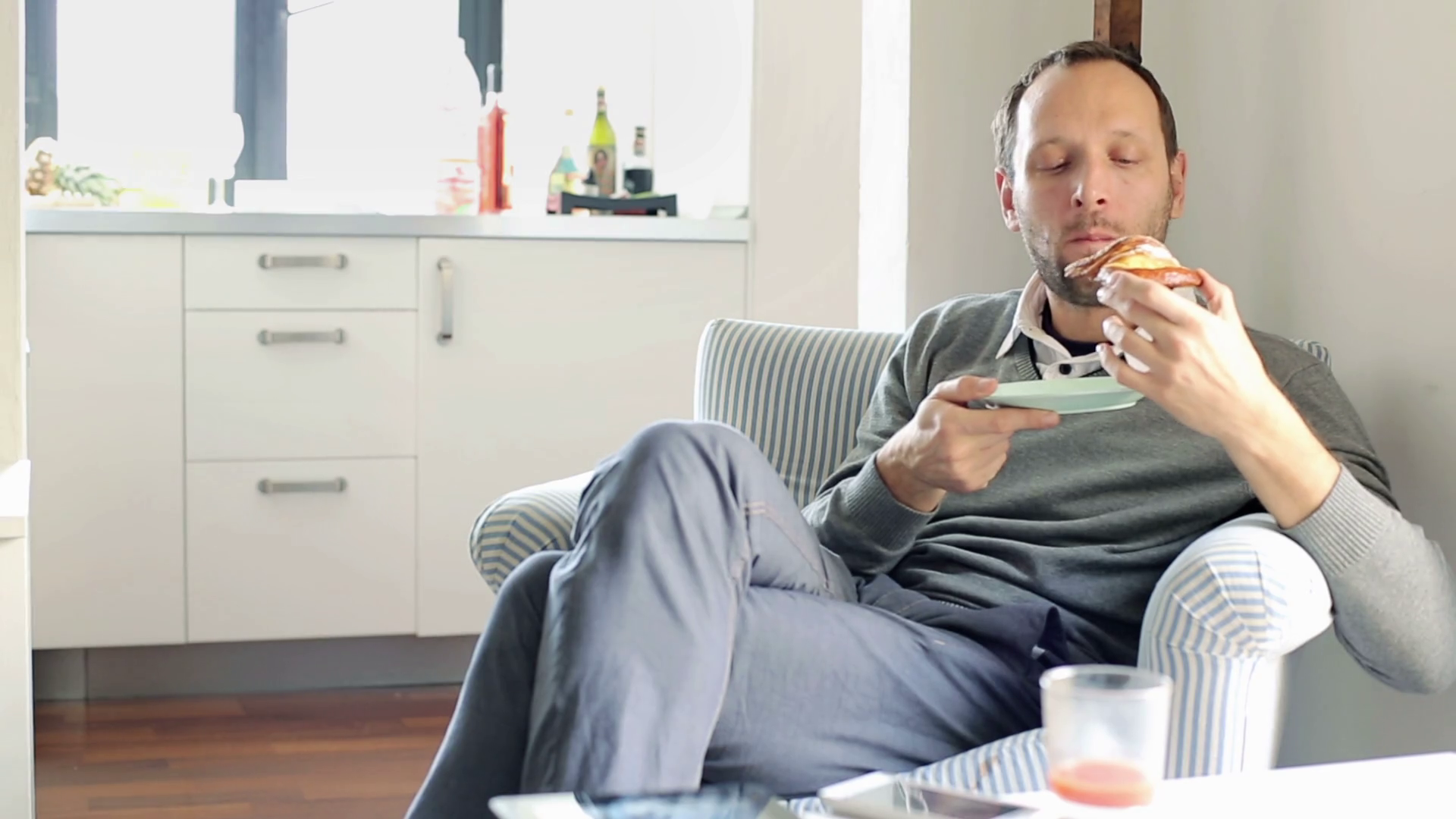 Man eating tasty dessert and drinking juice at home Stock Video Footage ...