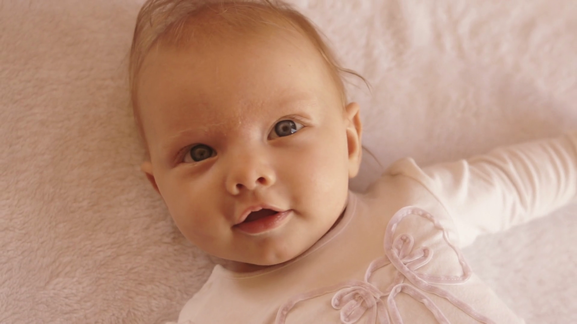 Overhead shot of young baby lying on back. Stock Video Footage 00:08 ...