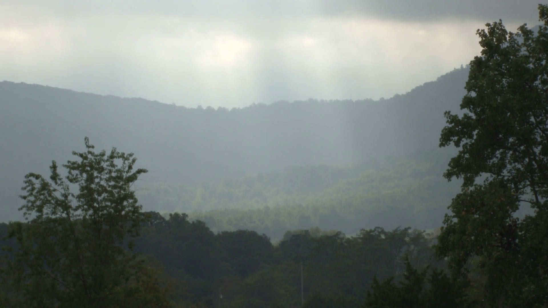 Sun Beams Through Hazy Hillside Sky Stock Footage SBV-300124772 ...