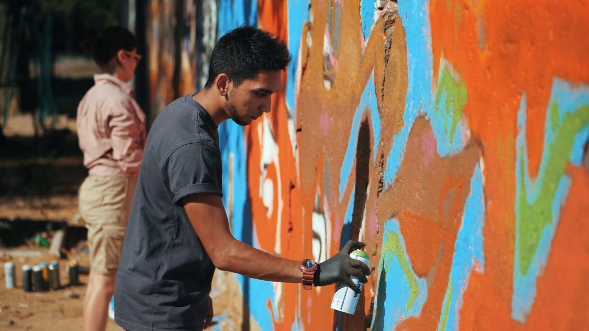 Someone Spray Painting A Wall