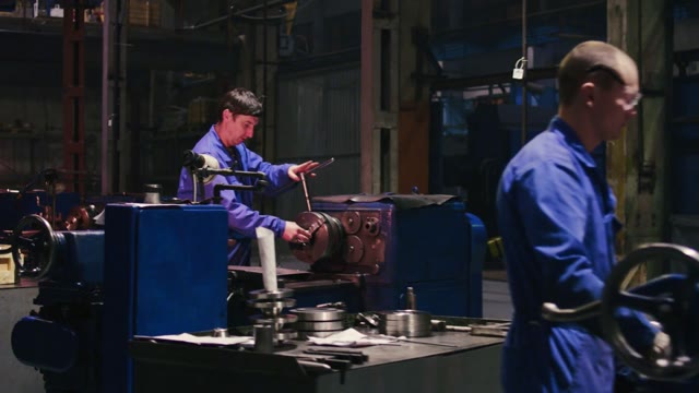 Factory Workers Operating Machines Stock Footage: Royalty-Free Video ...