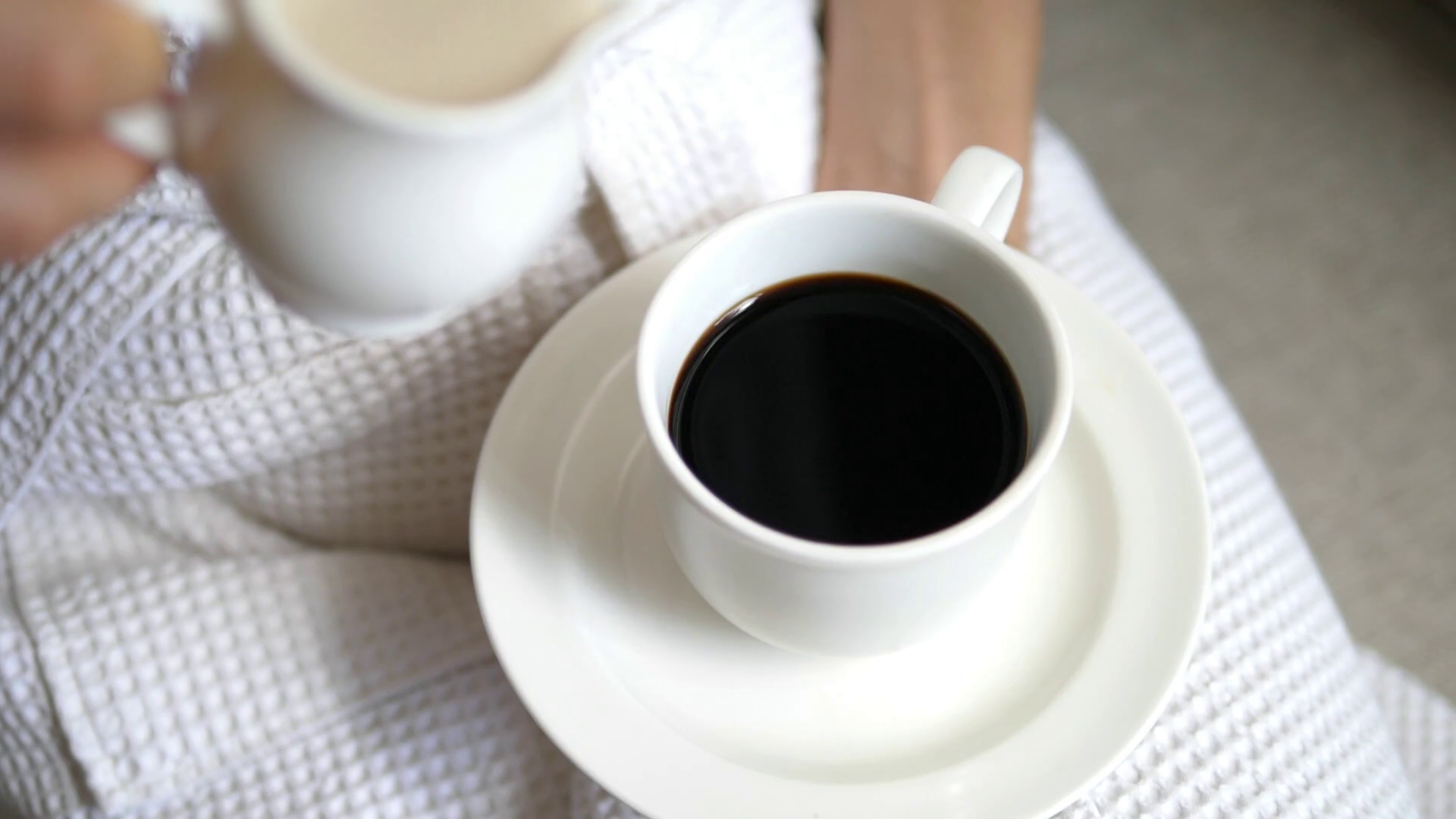 Pouring Milk In Cup Of Black Coffee Slow Motion Stock Video Footage