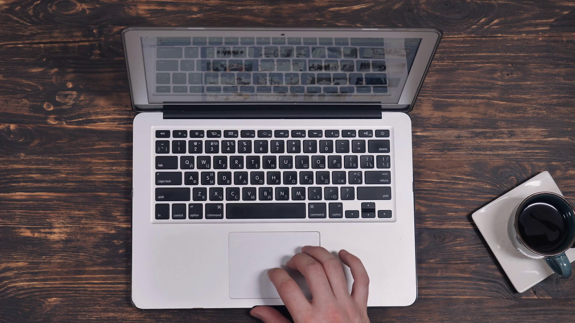 top view male hand scrolling on computer. Working place with wooden ...