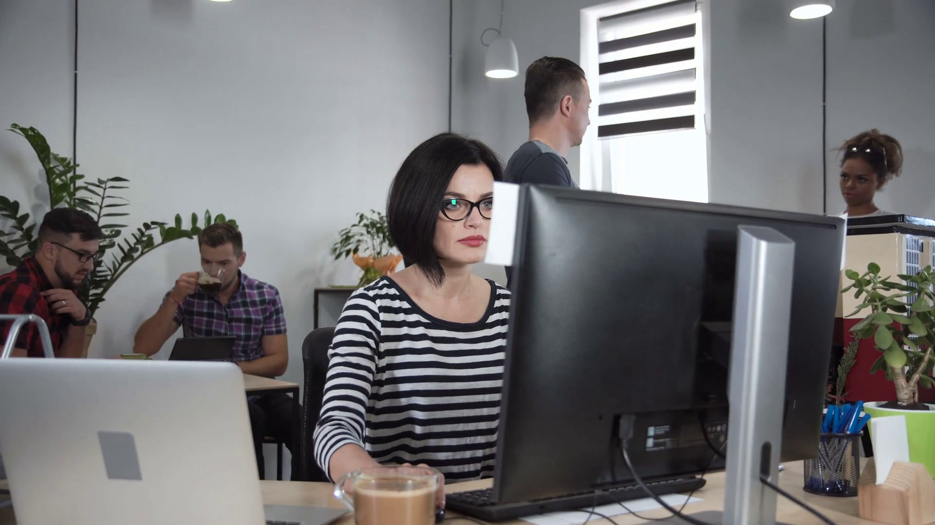 Young female architect working with computer creating new project of ...