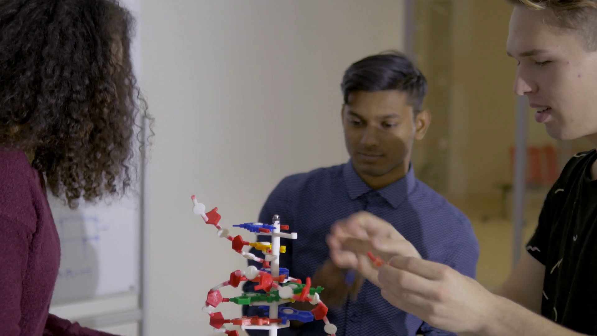 Young students constructing a DNA model during science class at school ...