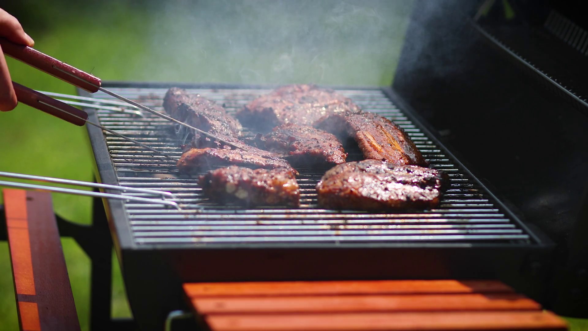 Man Flipping Barbecued Ribs On Coal Grill In Stock Footage SBV ...