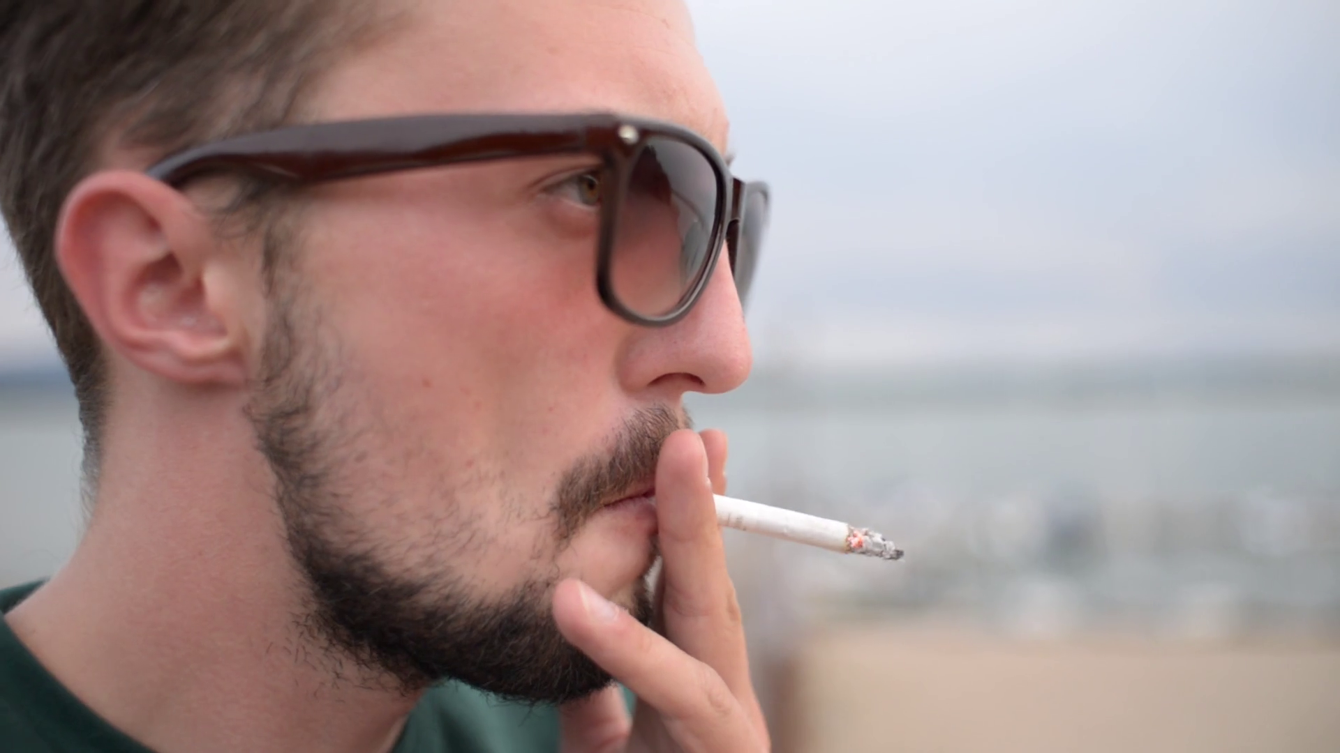 Young Man Smokes Cigarette Alone On Lake Pier Stock Footage SBV ...