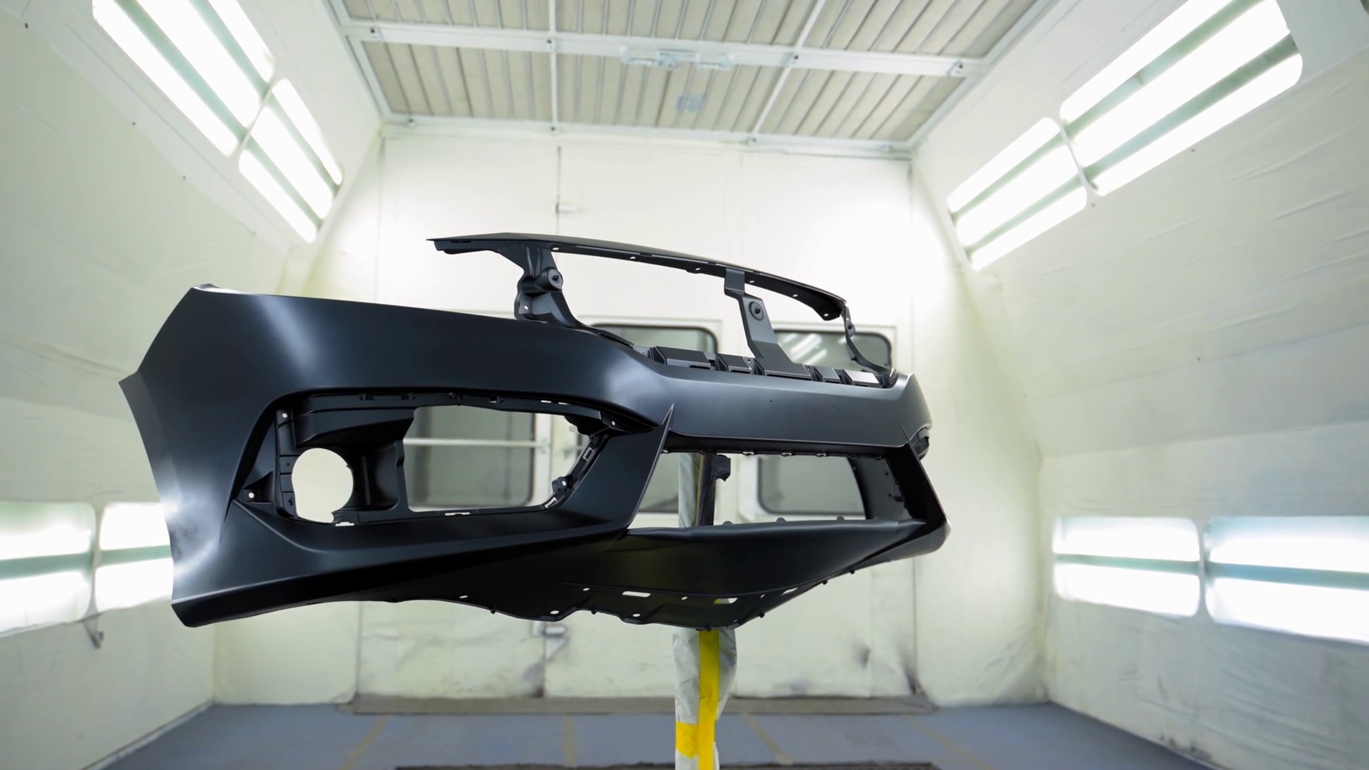 A Freshly Painted Car Bumper Hangs Suspended Stock Footage SBV ...