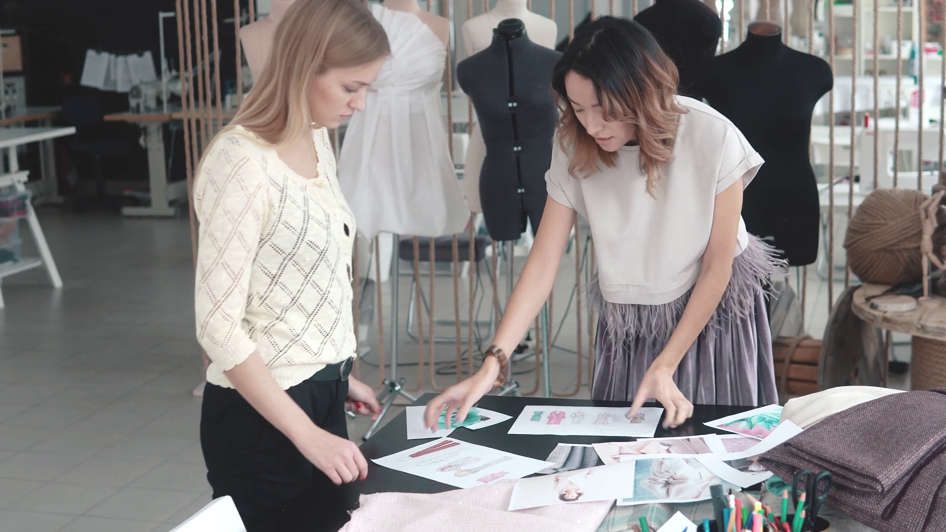 Fashion designers choose fabrics for a new collection of clothes. a ...