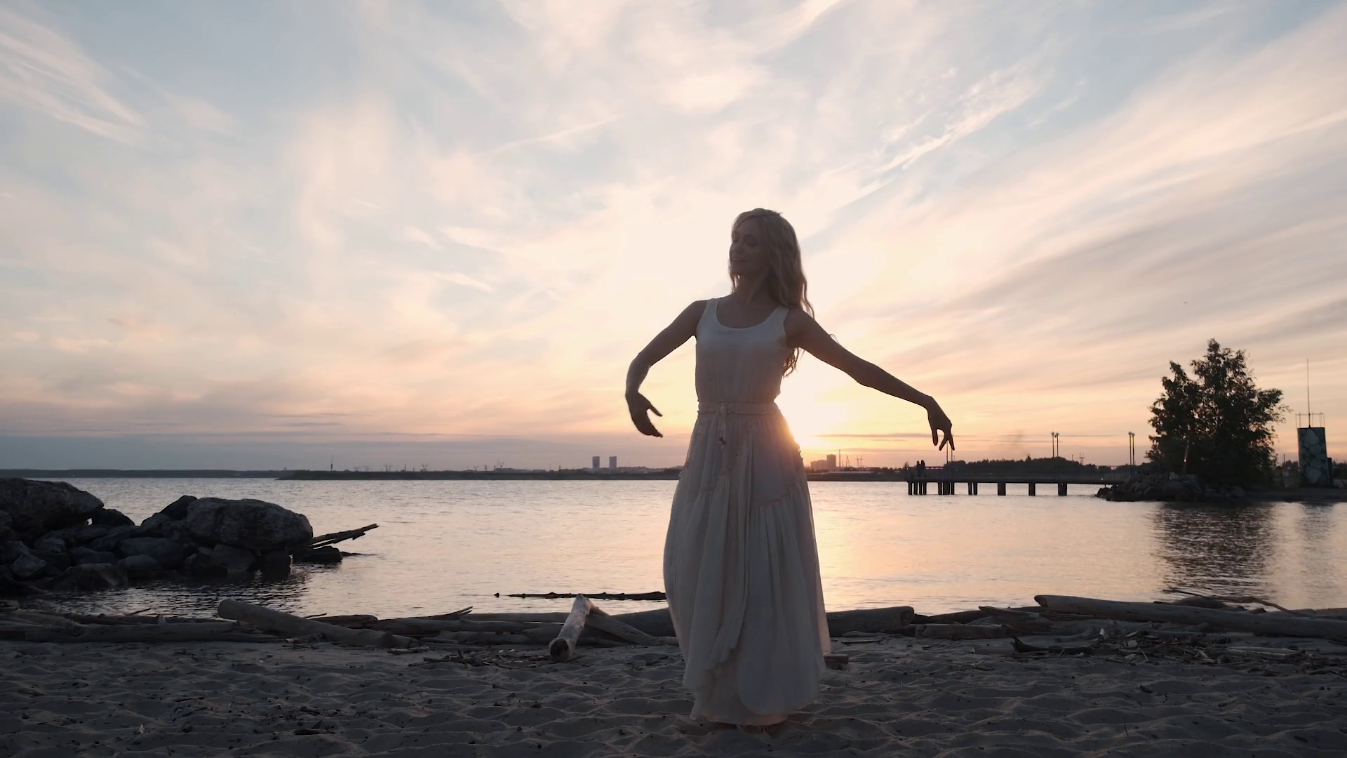 Girl In A Flowing Dress Dancing By The Sea At Sunset Stock Video