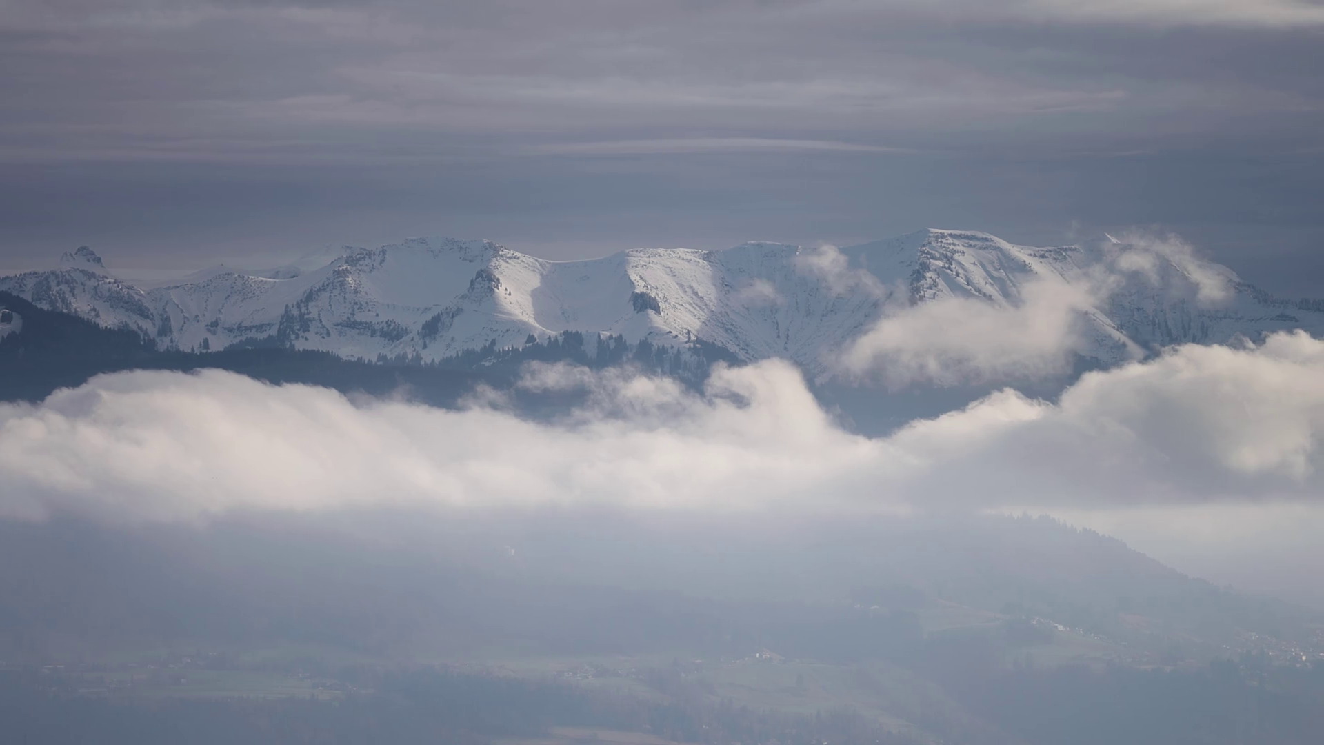 Snow-capped Mountains Rise Above Dense White Stock Footage SBV ...