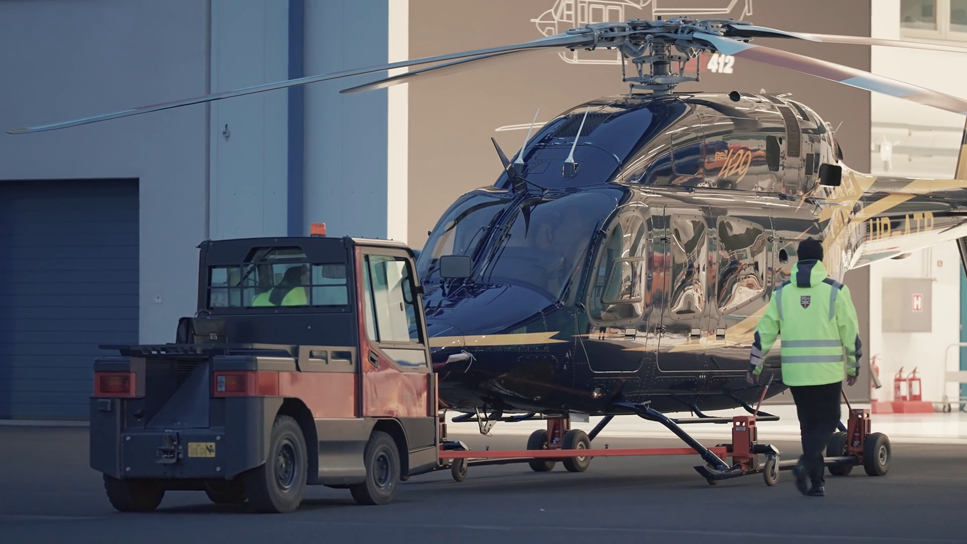 A Small Truck Tows Helicopter In Hangar At Stock Footage SBV-352418905 ...